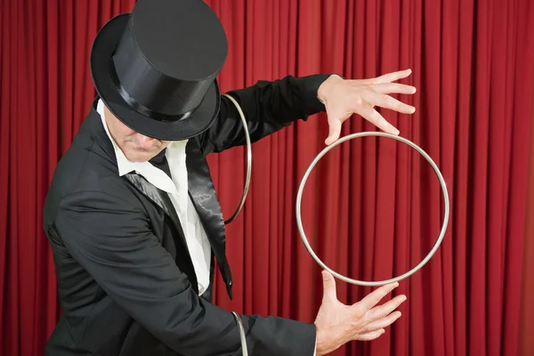 Magician performing on stage Stock Photo by ©microgen 115467958