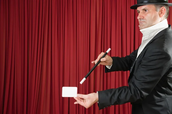 Magician performs magic trick — Stock Photo © microgen #115471126