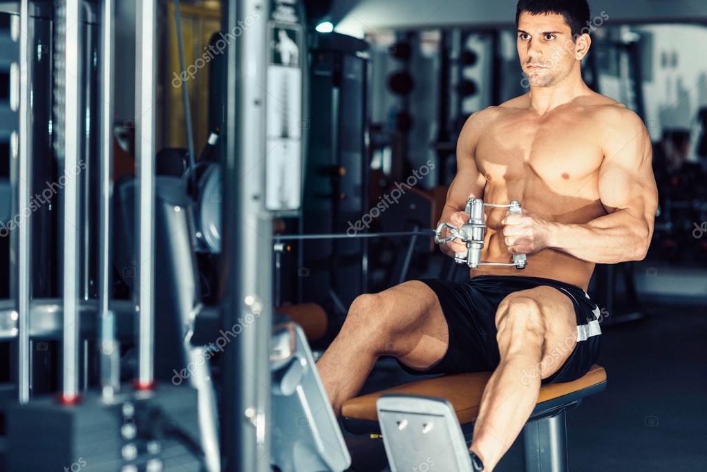 Man exercising on rowing machine — Stock Photo © microgen #115617852