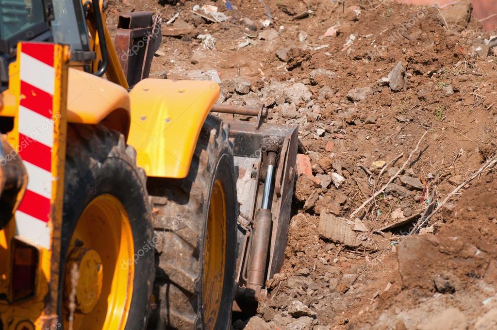 Front end loader on construction site — Stock Photo © microgen #115773516