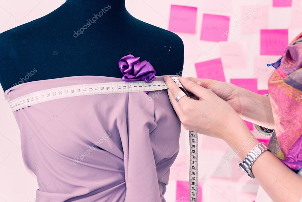 Designer hands measuring Clothing Stock Photo by ©microgen 115993096
