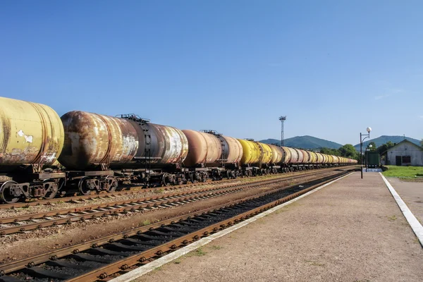 Freight trains.Railroad train of tanker cars transporting crude oil on ...
