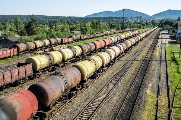 Freight trains.Railroad train of tanker cars transporting crude oil on ...