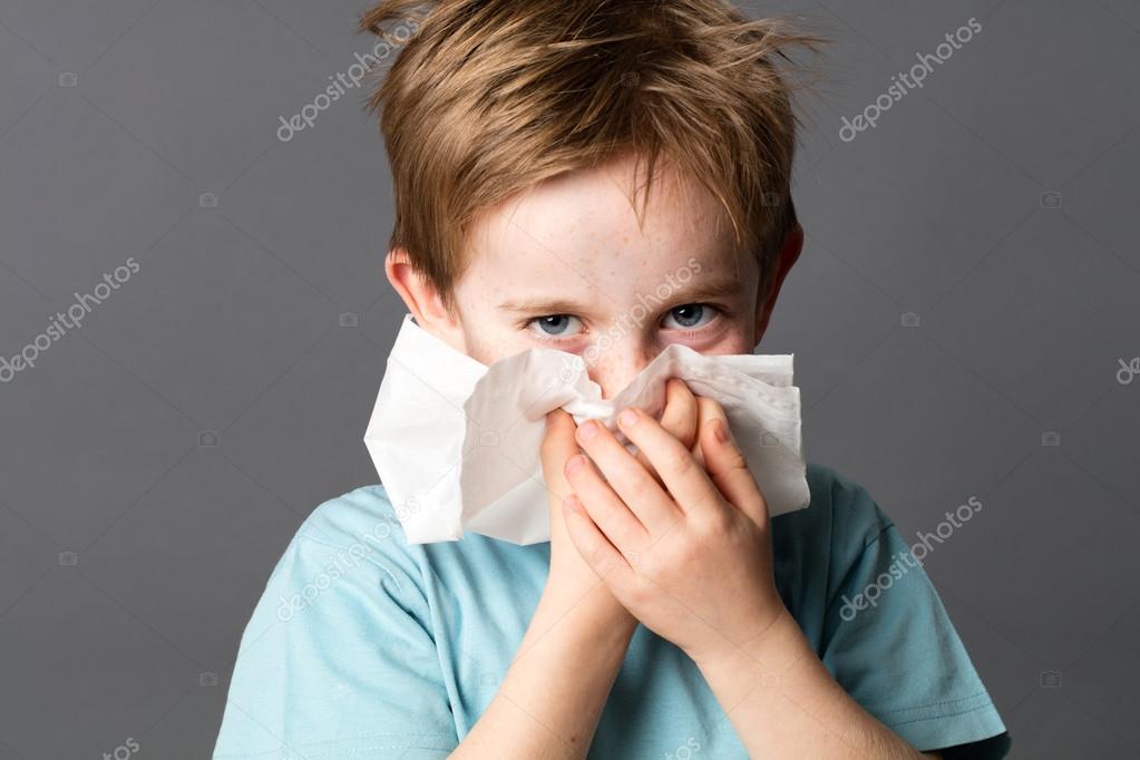 Beautiful boy using tissue to clean his nose after cold — Stock Photo ...