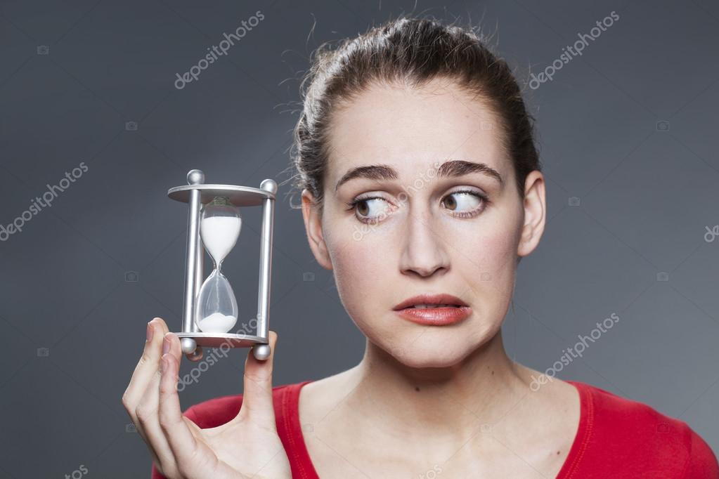 Anxious 20s girl with symbol of timing and deadlines in hands Stock ...
