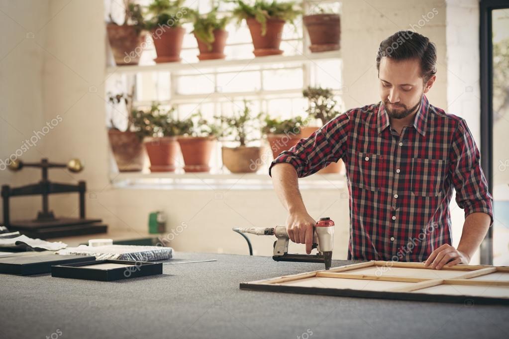 Framer using tool to frame artwork — Stock Photo © mavoimages #98272408