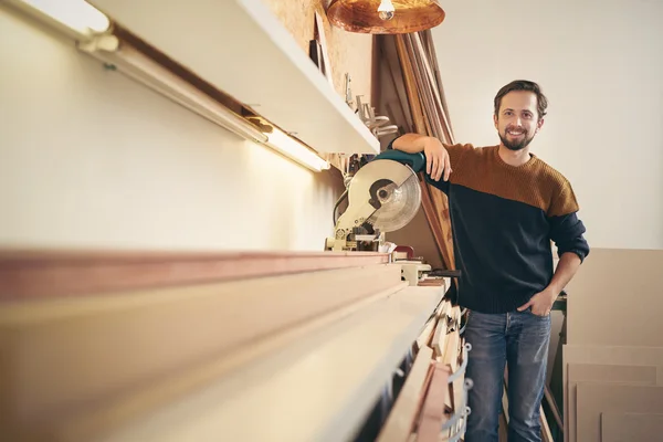 Framer standing alongside specialised tool - Stock Image - Everypixel