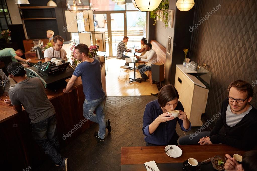 Modern coffee shop with customers — Stock Photo © mavoimages #98979900