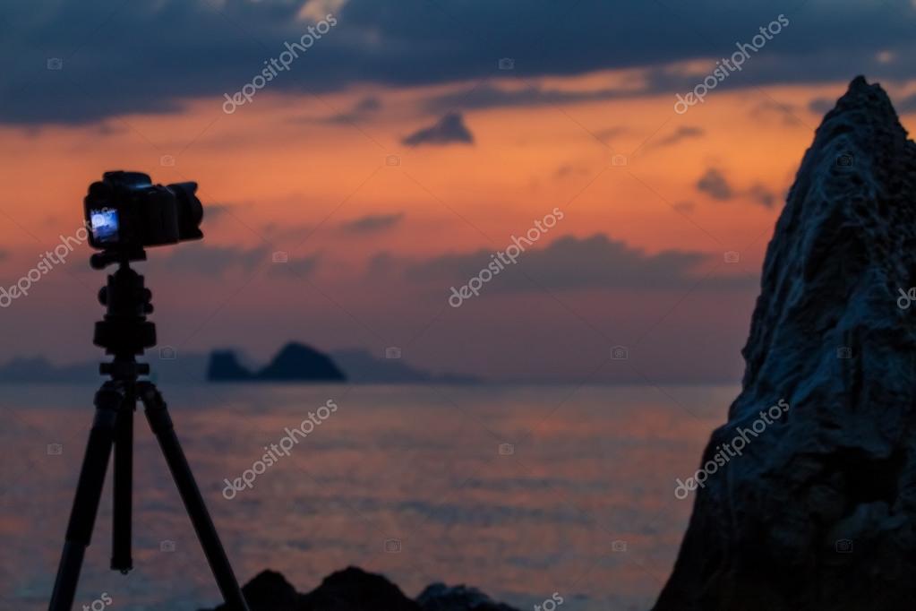 The camera standing on the beach of a tropical island and photographed ...