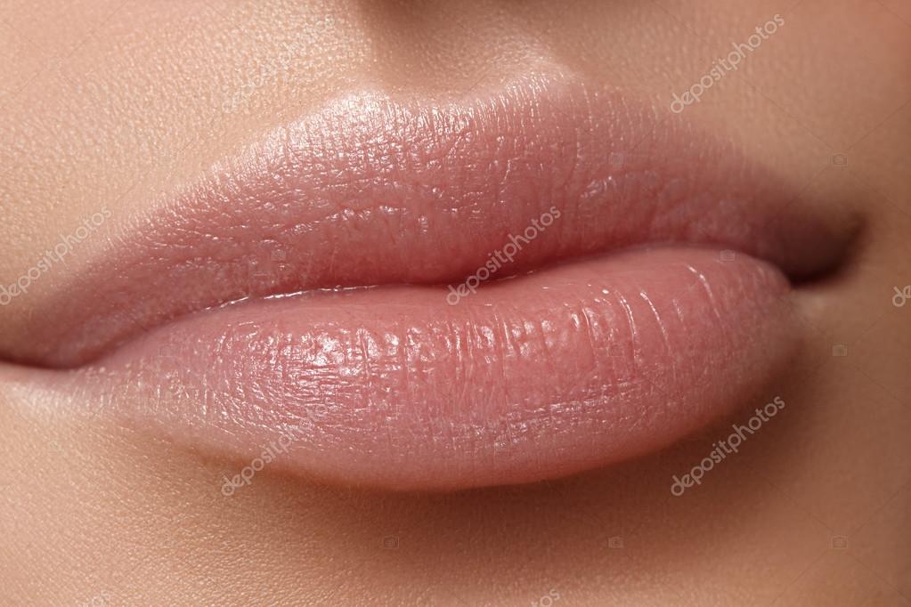 Face part. Beautiful female lips with natural makeup, clean skin. Macro ...