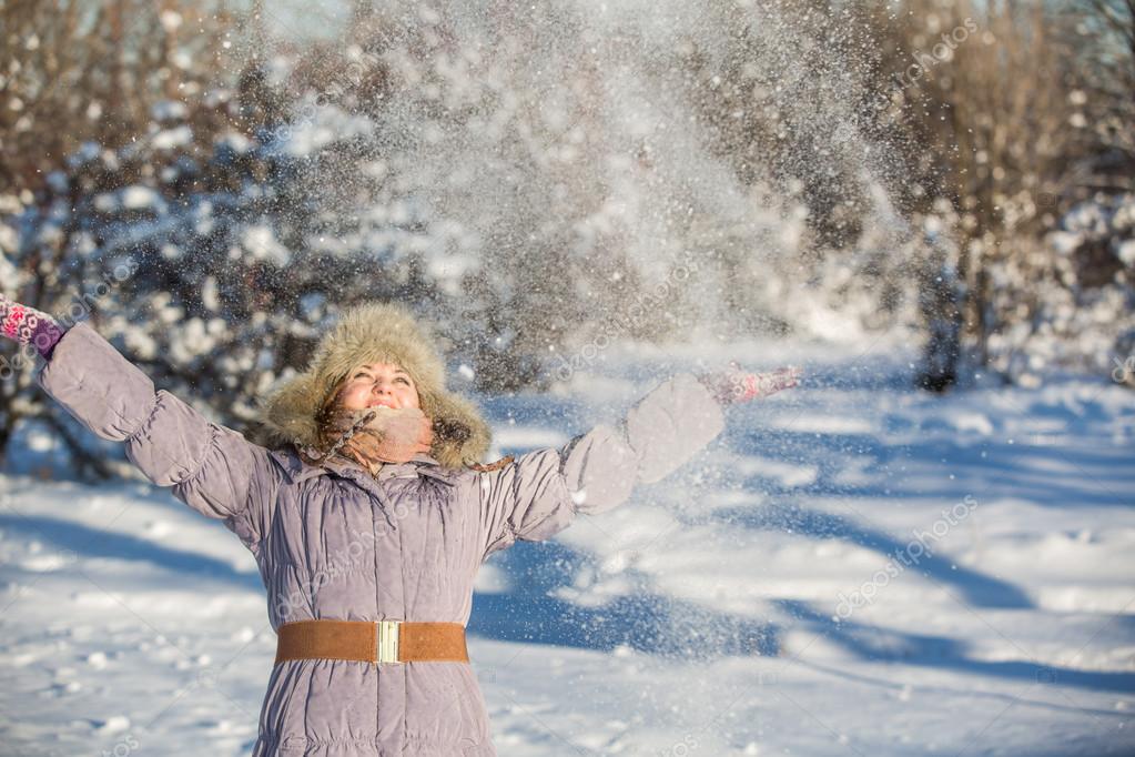 Girl throws snow up Stock Photo by ©Scharfsinn 111775218