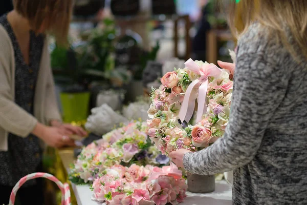 business owner selling behind counter with her bouquet of dried flowers ...