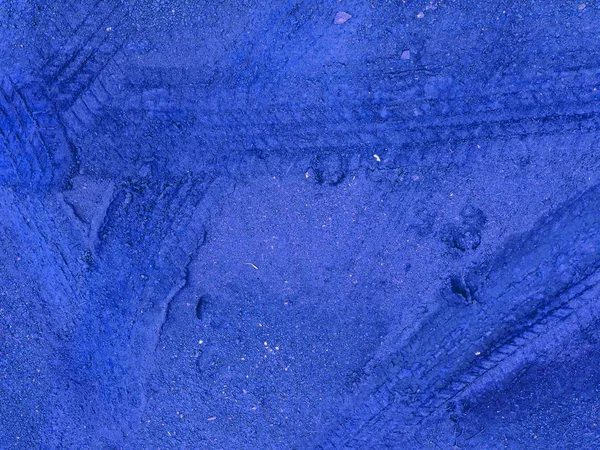 Blue Tire tracks on the blue road gravel stone background Stock Photo ...