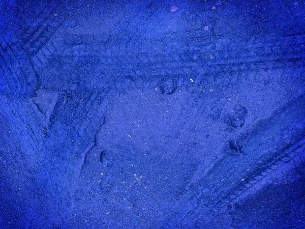 Blue Tire tracks on the blue road gravel stone background Stock Photo ...