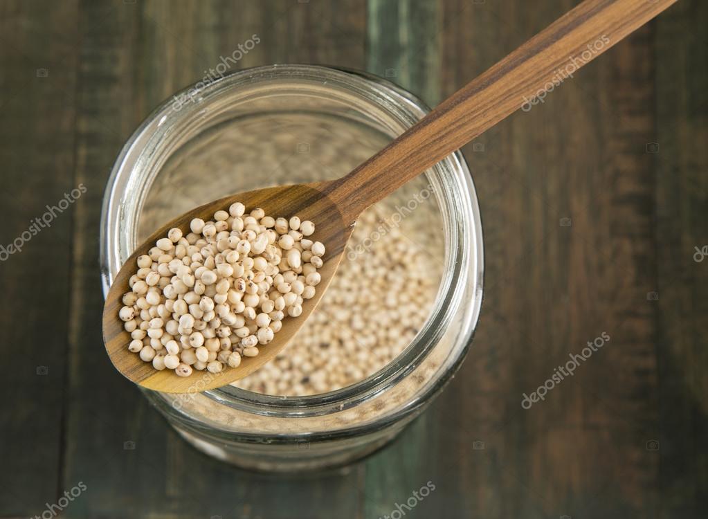 Millo cereal in a glass jar on wooden background — Stock Photo ...
