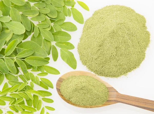 Moringa leaves and powder on white background Stock Photo by ...