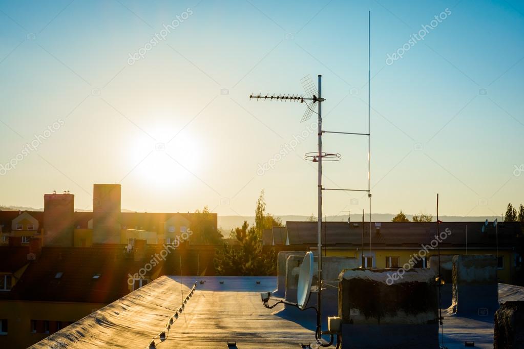 Simple antenna mast with antennas and satellite dish to receive digital ...