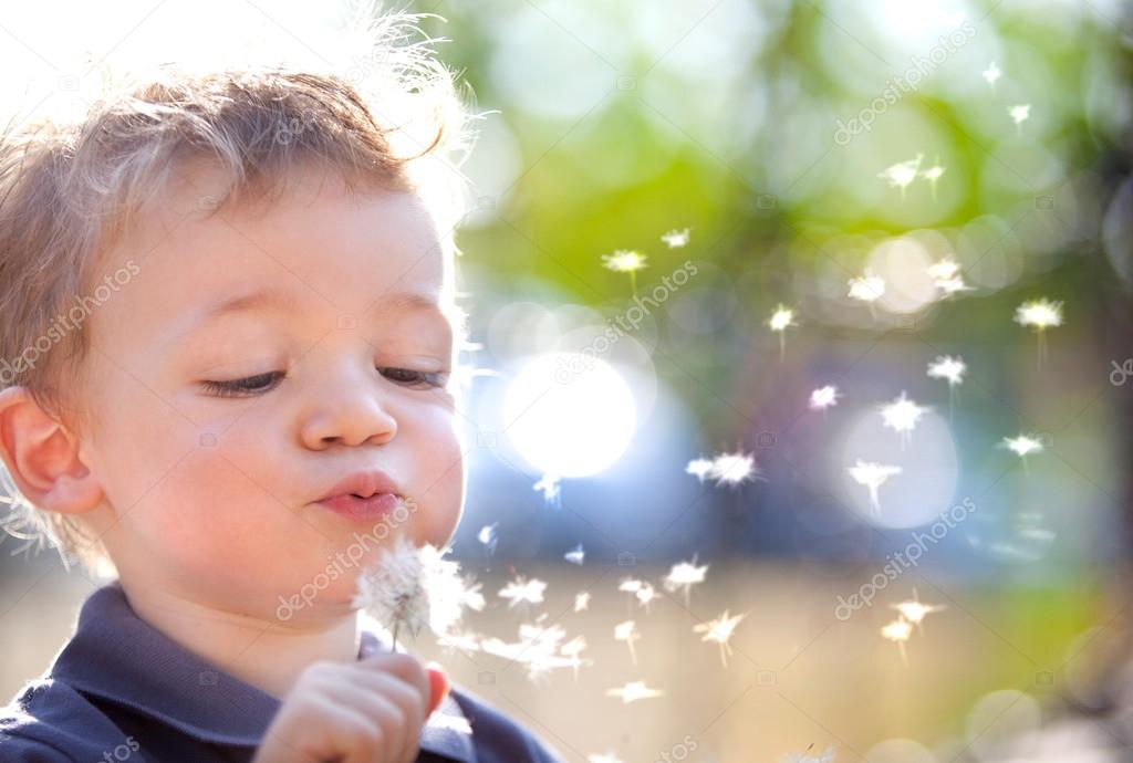 Happy smiling child playing with dandelion outdoor in a garden Stock ...