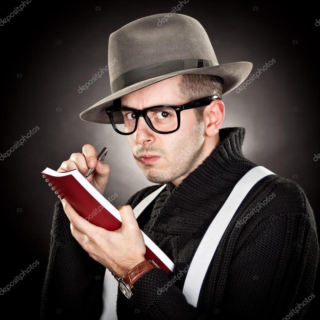 Young detective with hat portrait on black background Stock Photo by ...