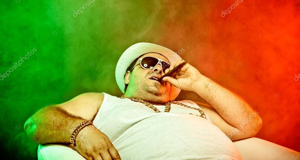 Italian funny mafia boss rapper with undershirt and sunglasses on smoky ...