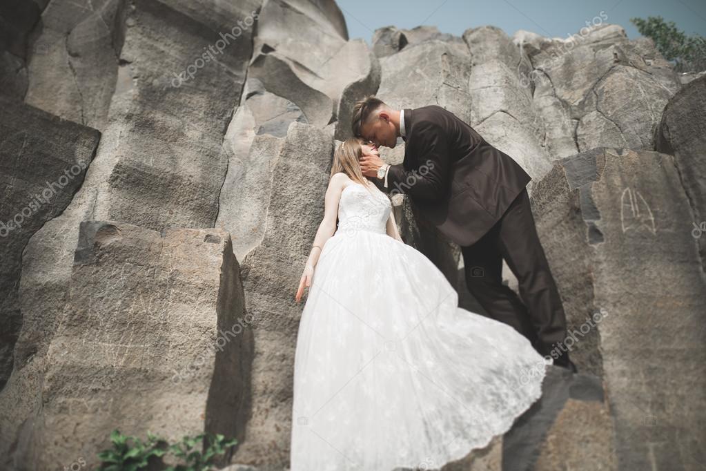 Wedding couple posing on great stones. The bride and groom — Stock ...