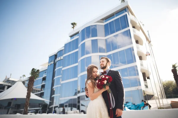 Elegant beautiful couple posing near modern glass building - Stock ...