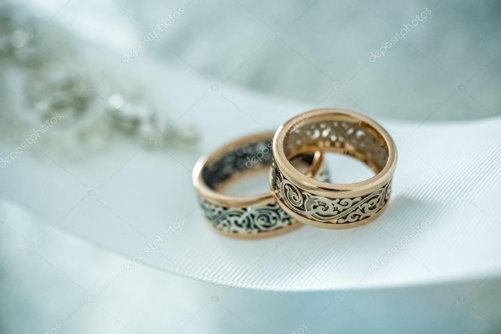 Two wedding rings with rare design on white broad ribbon Stock Photo by ...