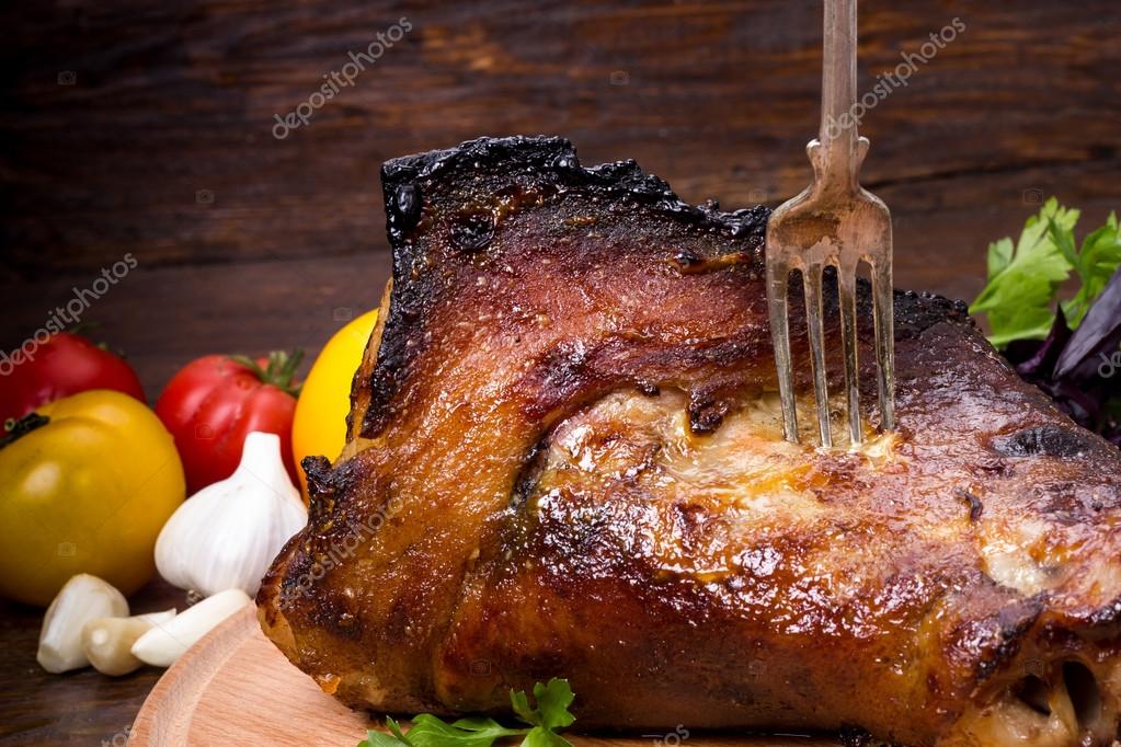 Shin, knee wild boar - roast pork leg with vegetables Stock Photo by ...