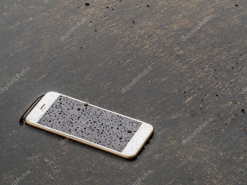 Wet smart phone dropped on flooding floor Stock Photo by ©Poravute ...