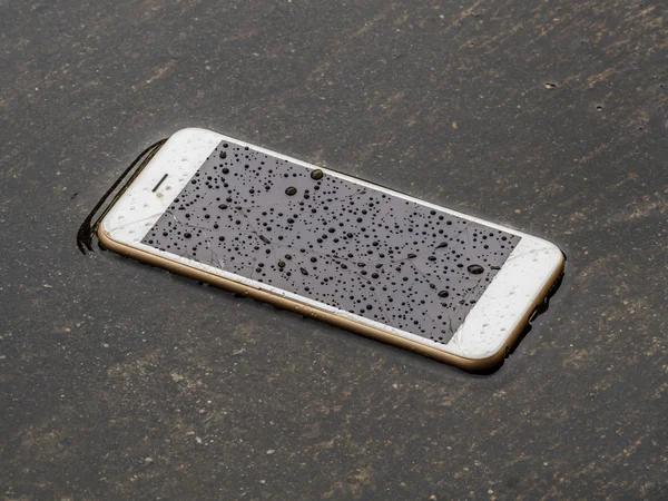 Wet smart phone dropped on flooding floor Stock Photo by ©Poravute ...
