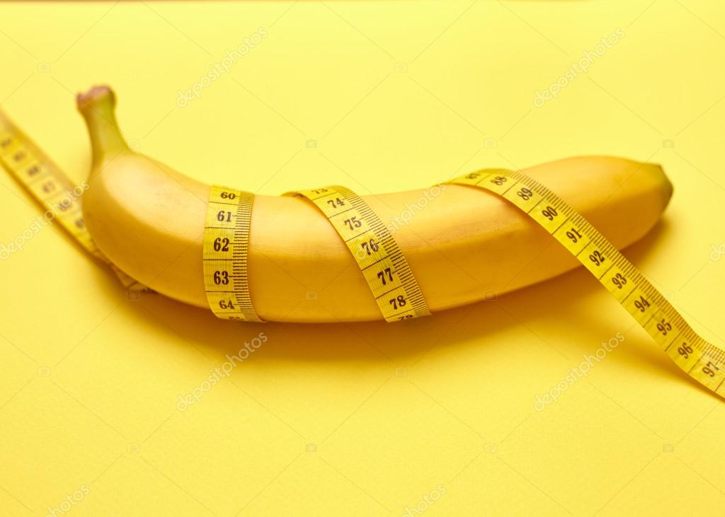 Isolated banana with measuring tape on a yellow background Stock Photo ...