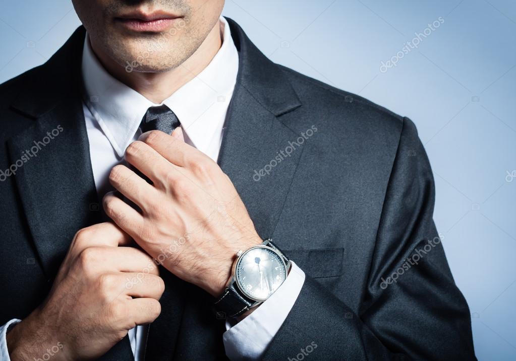 Business man fixing his suit Stock Photo by ©kieferpix 106401382