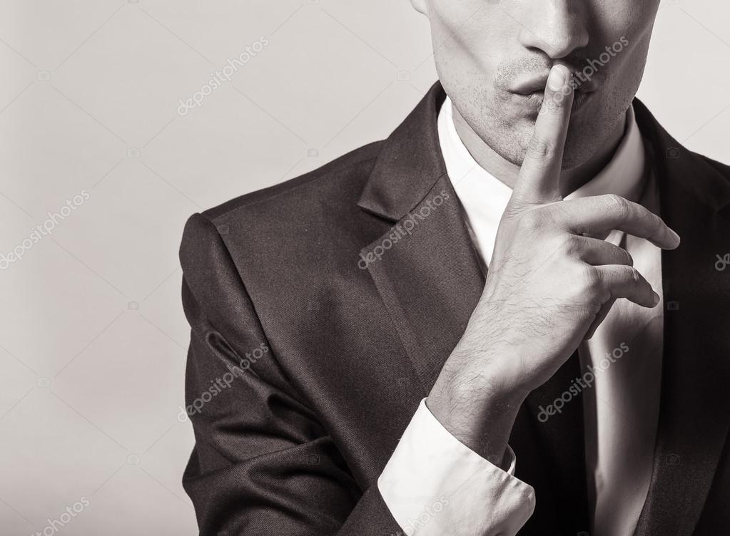 Man making silence gesture — Stock Photo © kieferpix #106401760