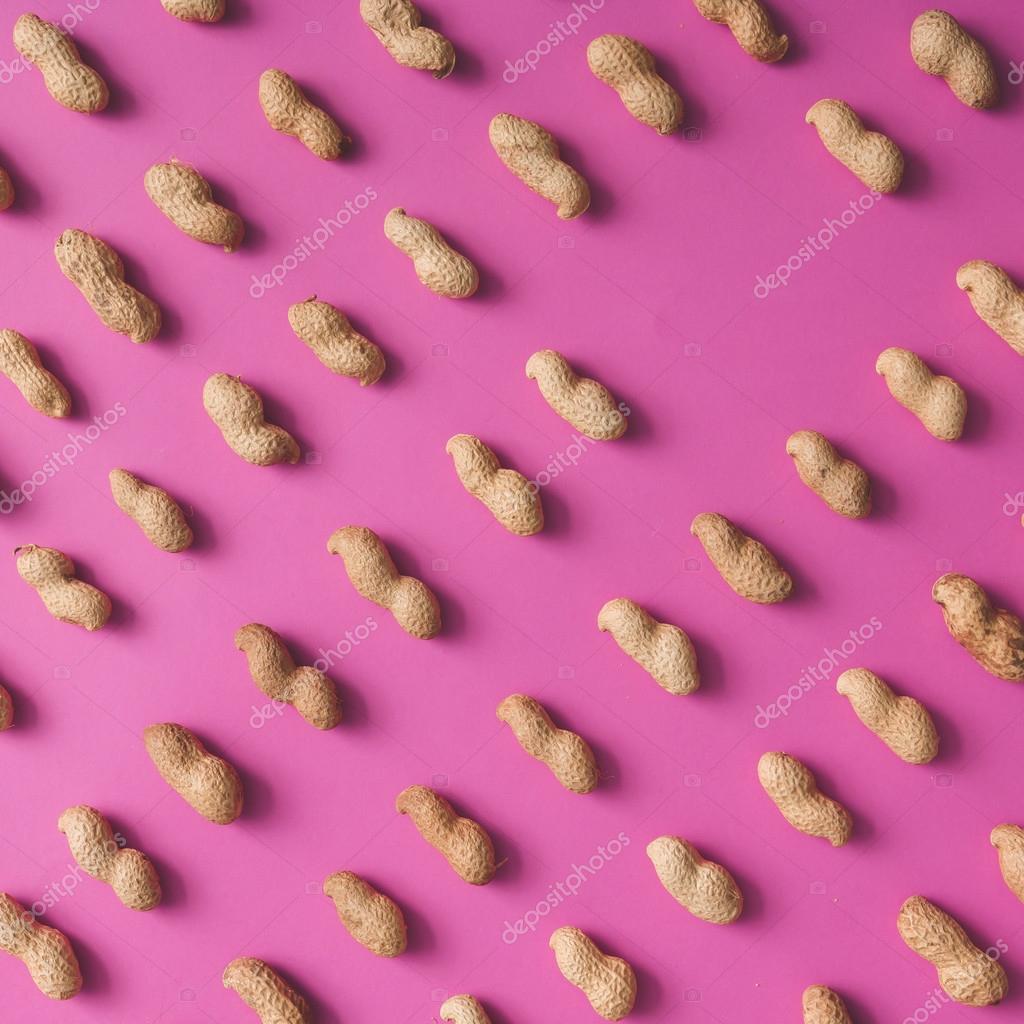Peanuts pattern on pink background Stock Photo by ©Zamurovic 108020906