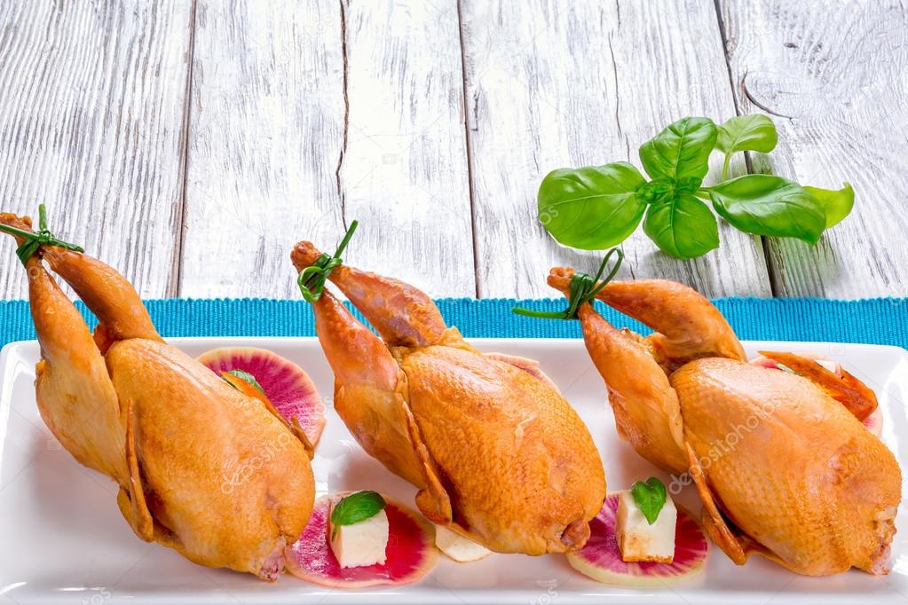 Quails on a rectangular white dish, close-up Stock Photo by ...