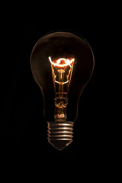 Glowing light bulb without wires on black background - Stock Image ...