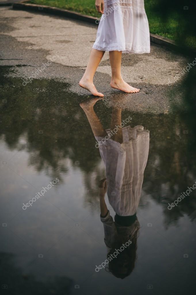 Woman walking barefoot through puddle — Stock Photo © Photo_life #106485212