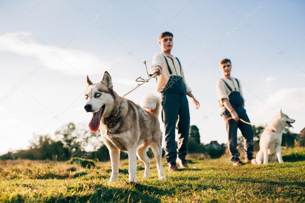 Two twin brothers with husky dogs — Stock Photo © Photo_life #109234264