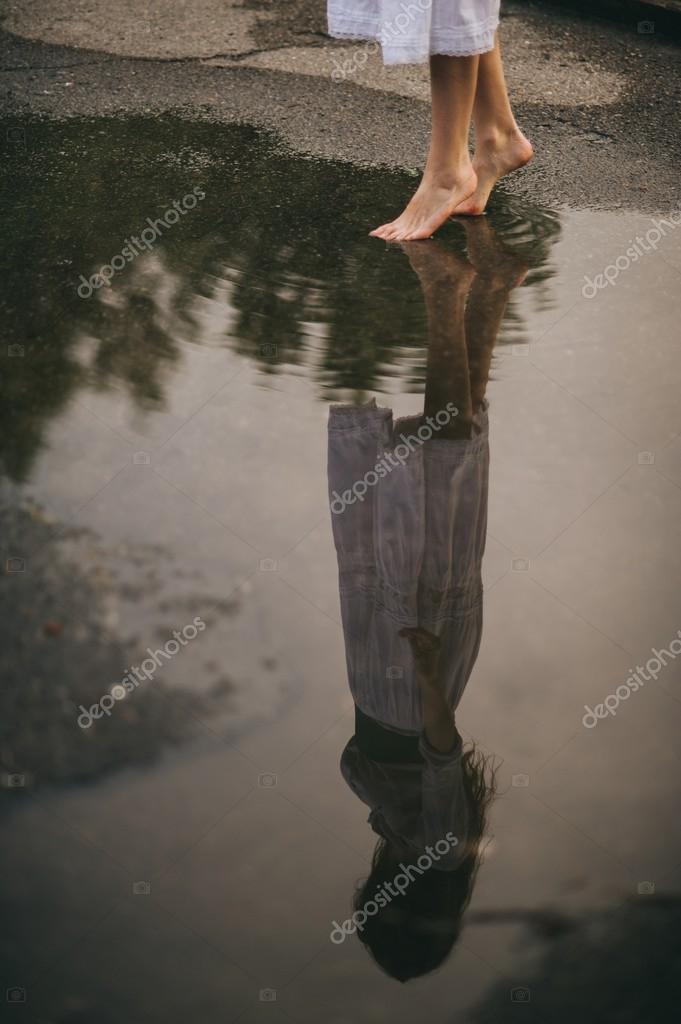 Woman walking barefoot through puddle — Stock Photo © Photo_life #115476370