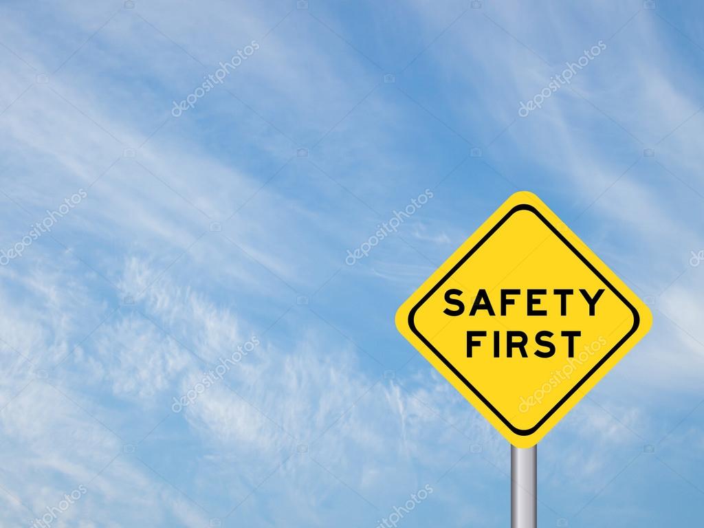 Wording "Safety first" on yellow traffic sign with pole on the b Stock ...