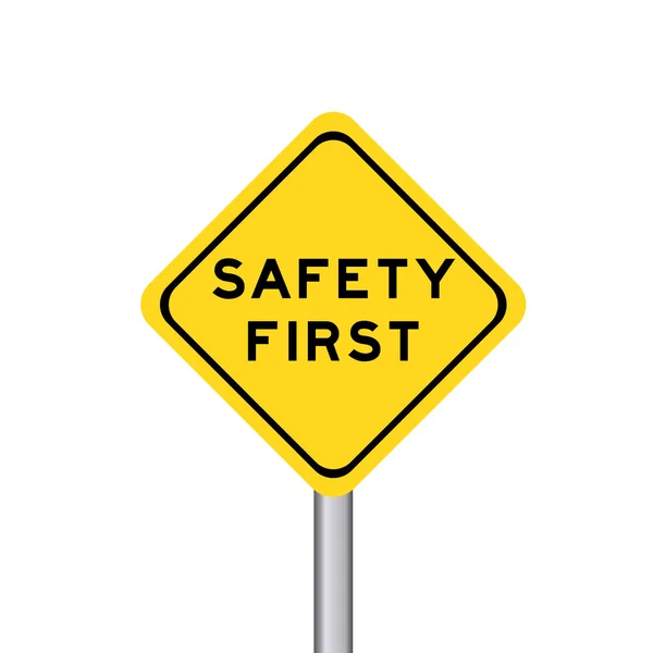 Wording "Safety first" on yellow traffic sign with pole on the b Stock ...