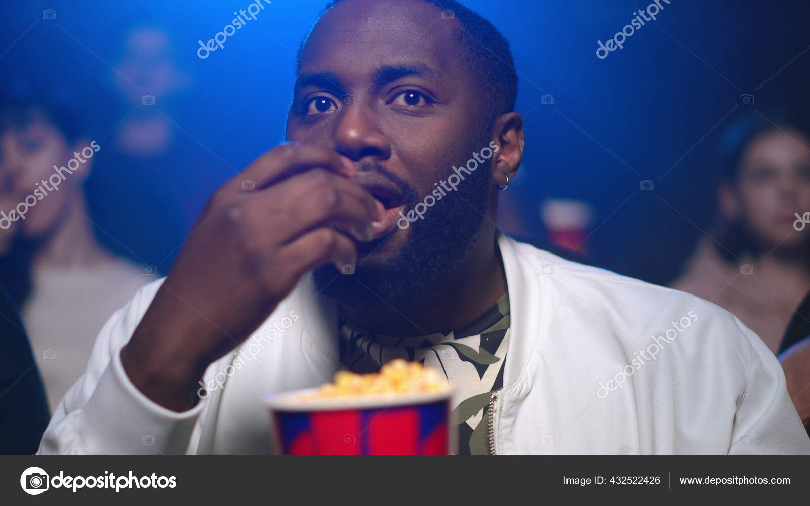 African man eating popcorn in movie theater. Afro american guy watching film. — Stock Photo ...