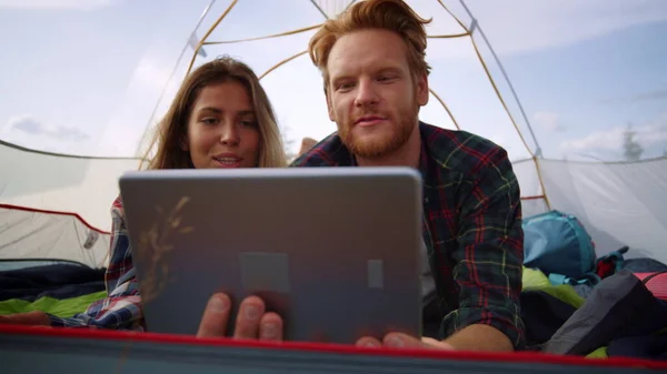 Young couple talking during online video call on tablet computer in ...