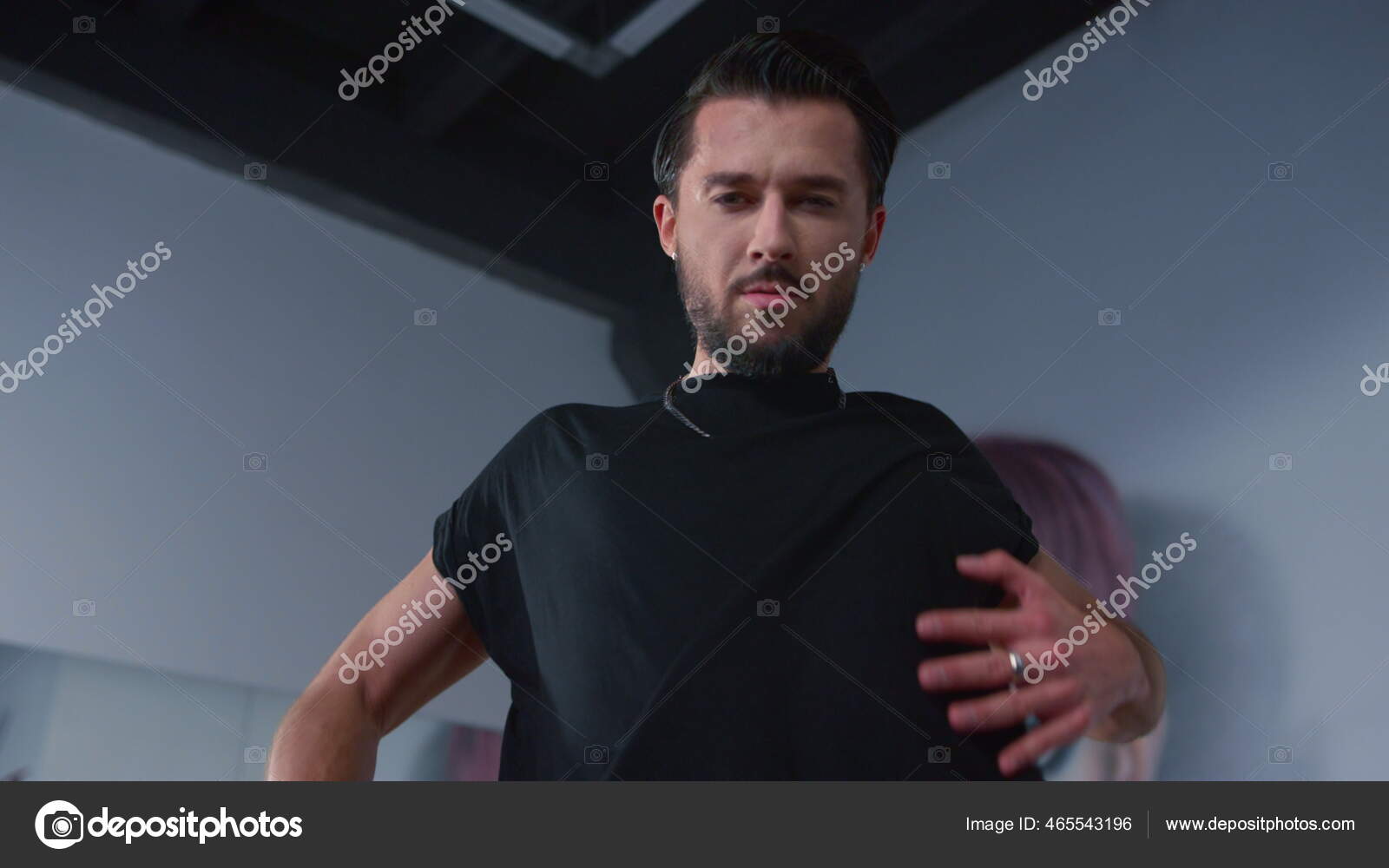 Attractive dancer raising hands in modern class. Young man dancing ...