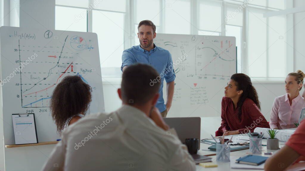 Confident business man asking questions multiethnic colleagues in ...
