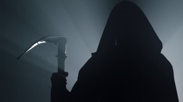 Silhouette death with scythe indoors. Man in costume grim reaper on ...