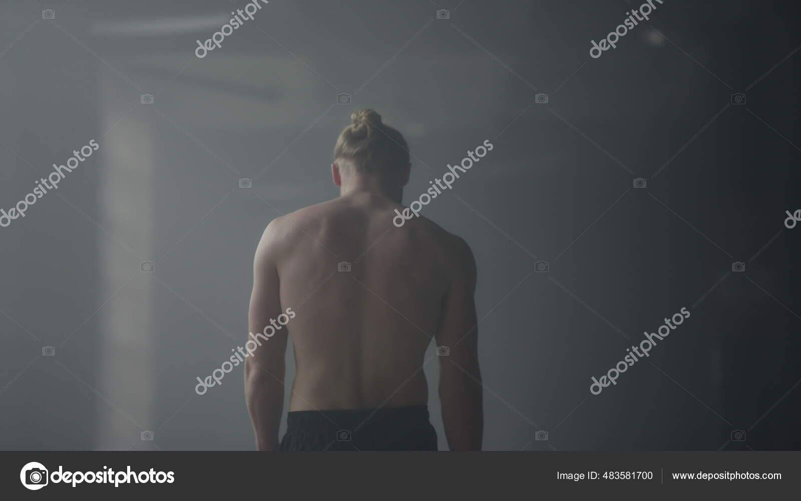 Sportsman taking rest after workout. Fitness man walking in loft ...