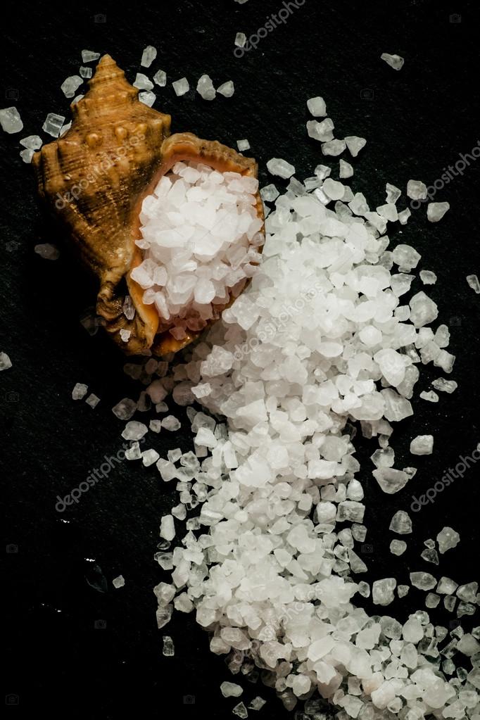 Sea salt in a shell on a dark stone background — Stock Photo © 5PH ...