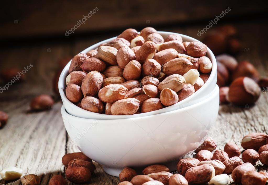 Raw peeled peanuts in a white porcelain bowl Stock Photo by ©5PH 108648298