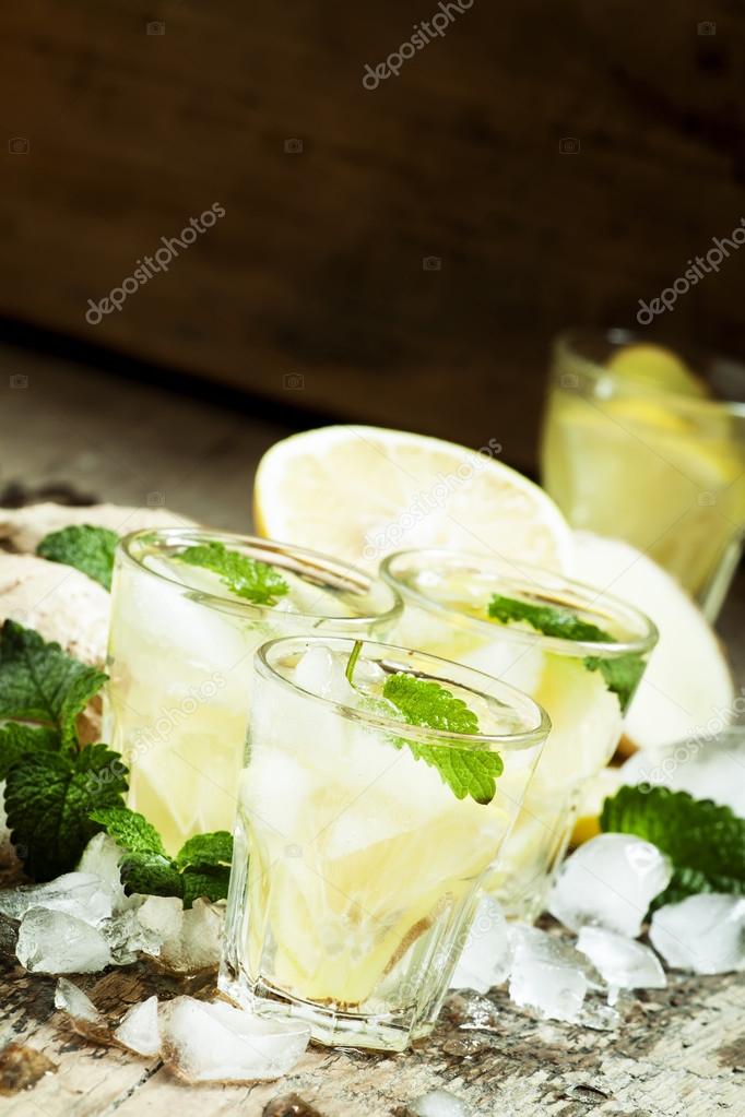 Refreshing cold drink with ginger, lemon, ice and mint Stock Photo by ...